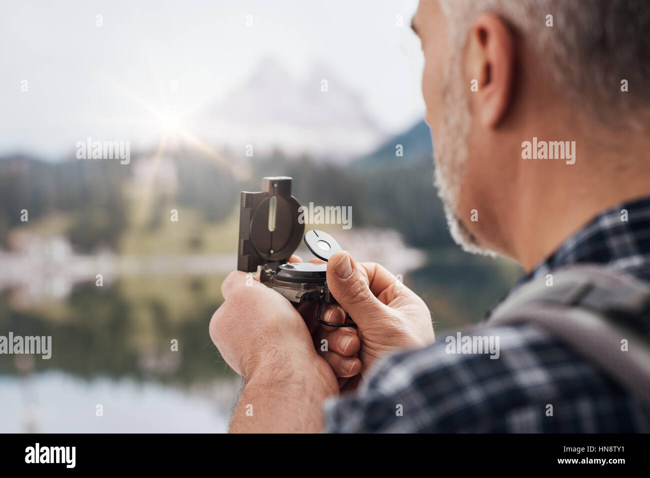Man using compass on map hi-res stock photography and images - Alamy