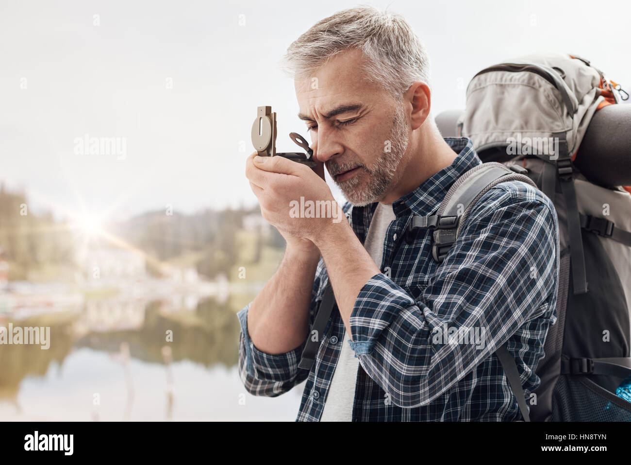 Man using compass on map hi-res stock photography and images - Alamy
