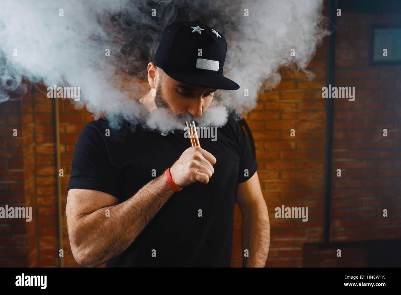 Man vaping an electronic cigarette Stock Photo - Alamy