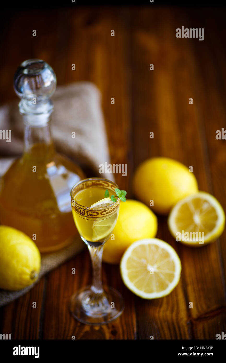 sweet lemon alcoholic brandy in the decanter on a dark table Stock ...