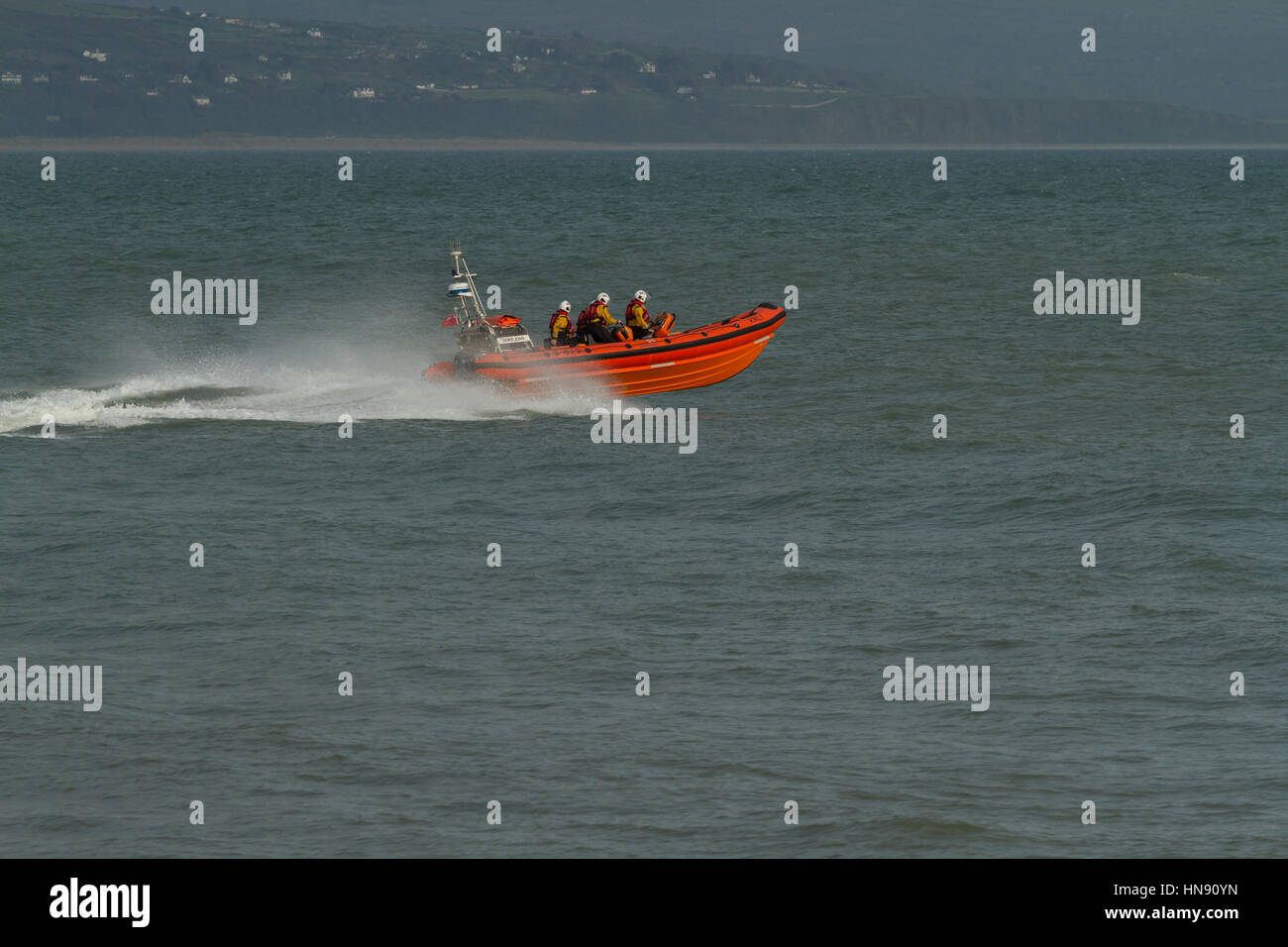 RNLI Lifeboat Inshore RIB launching off Criccieth Beach North Wales UK ...