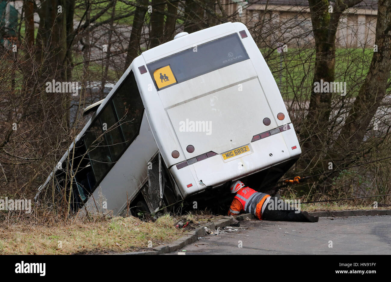 Emergency services work to right a school bus which overturned near Our ...