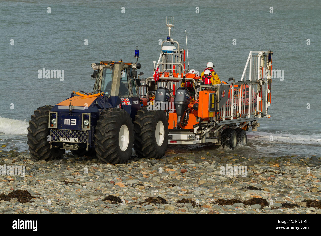 RNLI Lifeboat Inshore RIB launching off Criccieth Beach North Wales UK ...