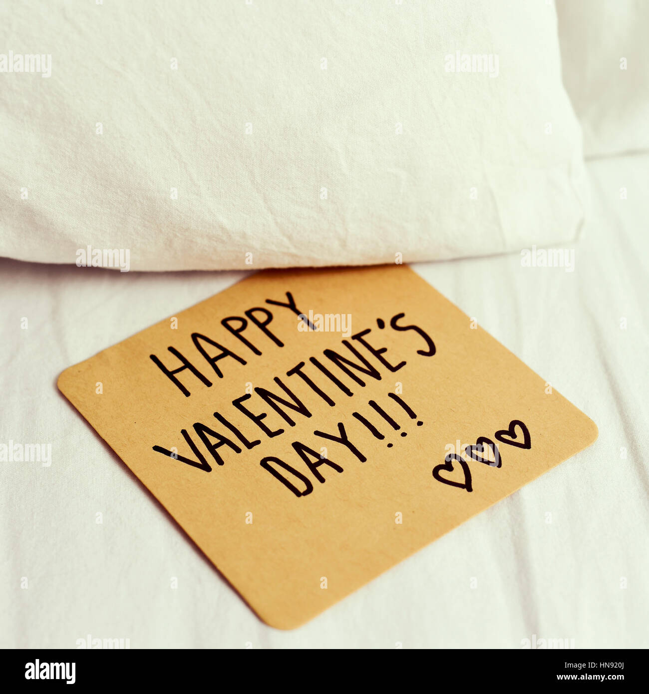 closeup of a brown paper note with the text happy valentines day ...