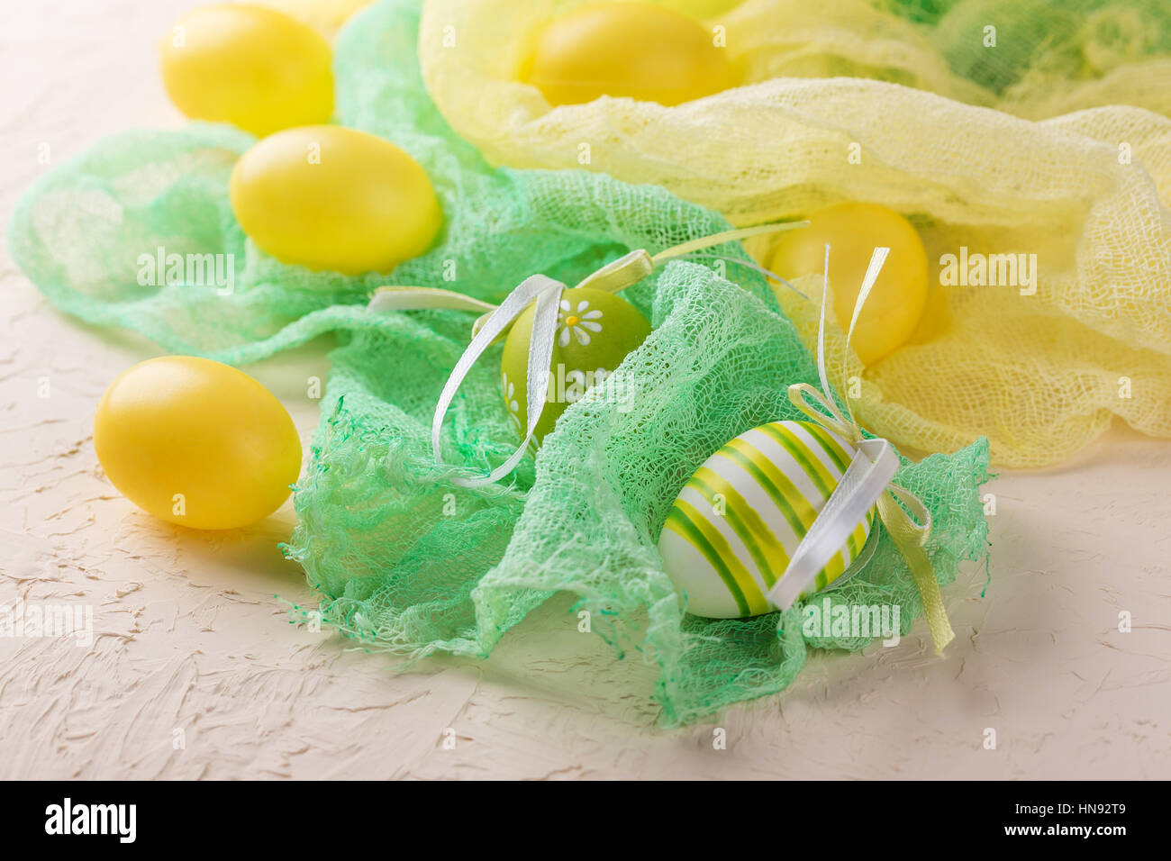 Green and yellow Easter eggs on a light background Stock Photo - Alamy