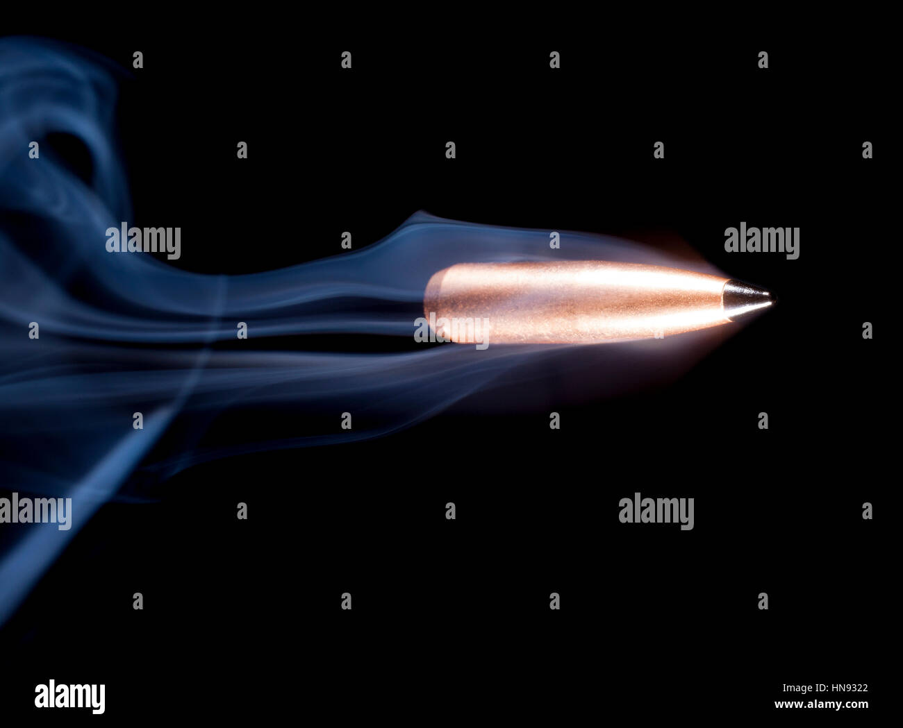Copper plated bullet with a polymer tip speeding with smoke Stock Photo ...