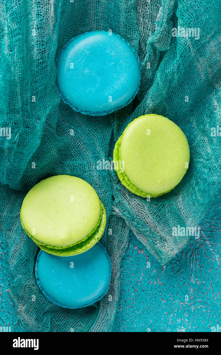Cookies macaroon blue and green color on a turquoise background. Top ...