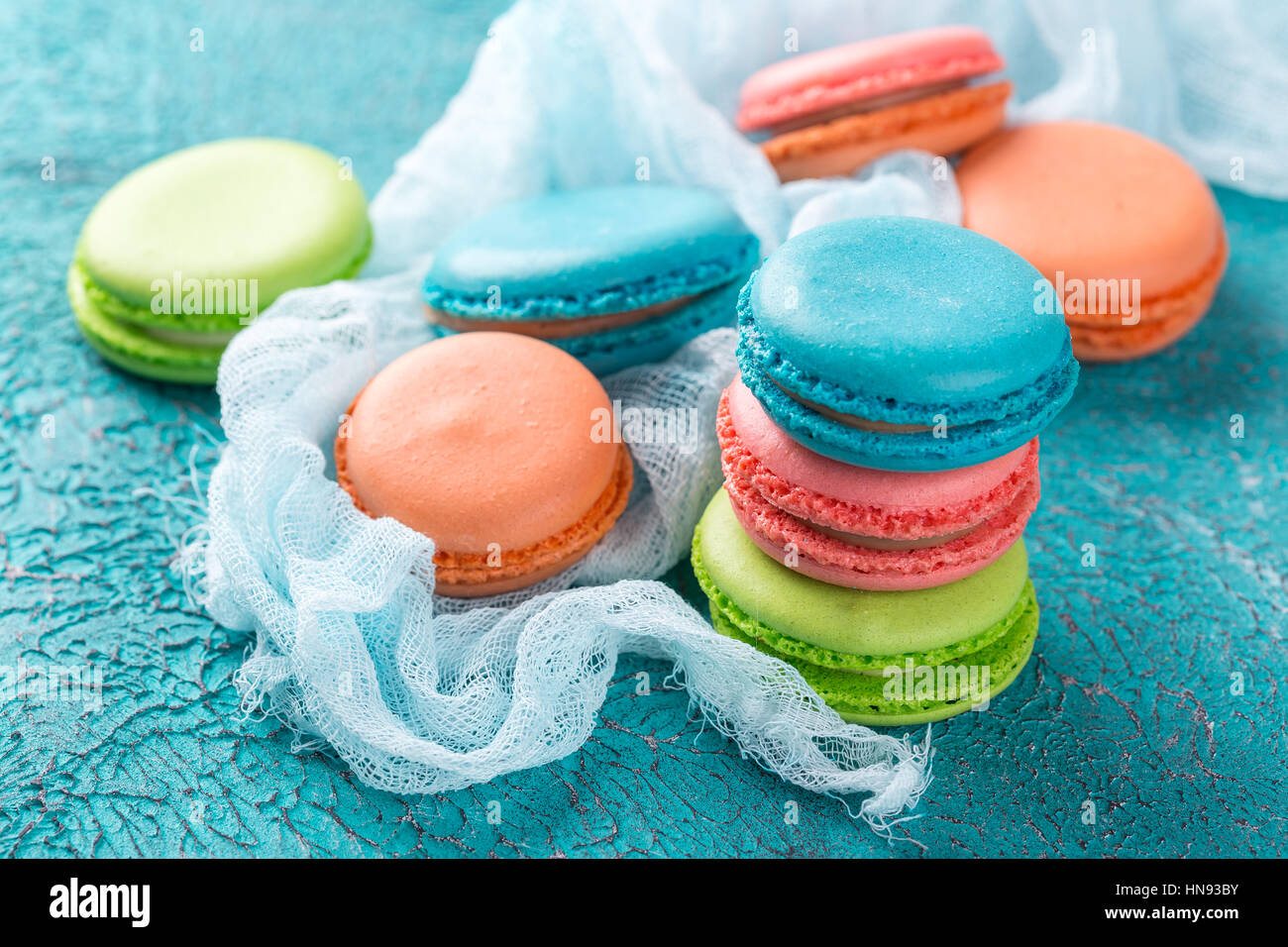 Cookies macaroon on a turquoise background, colorful almond cookies ...