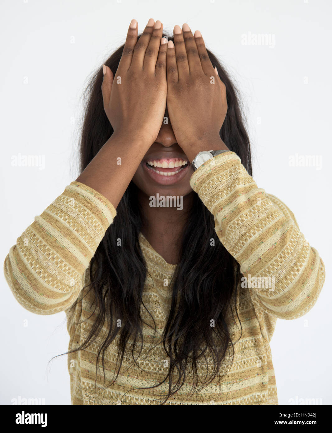 Black girl doing the peek-a-boo gesture Stock Photo - Alamy
