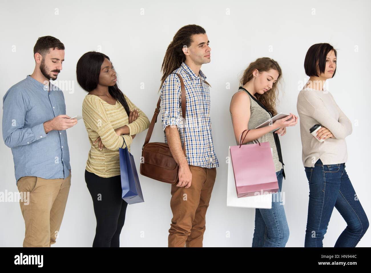 Diverse people queueing in line studio Stock Photo - Alamy