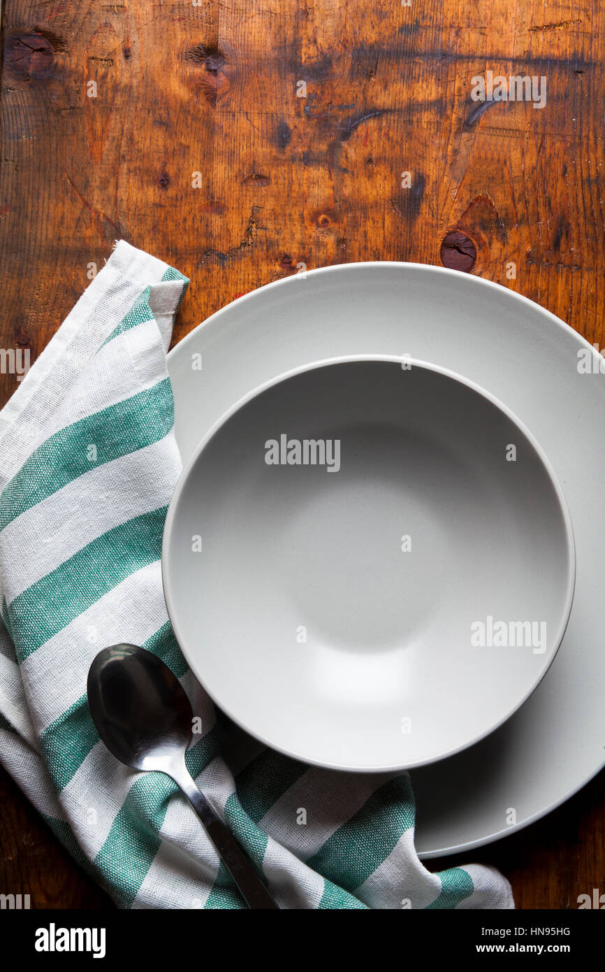 A set of plates on a wooden table. table setting Stock Photo - Alamy