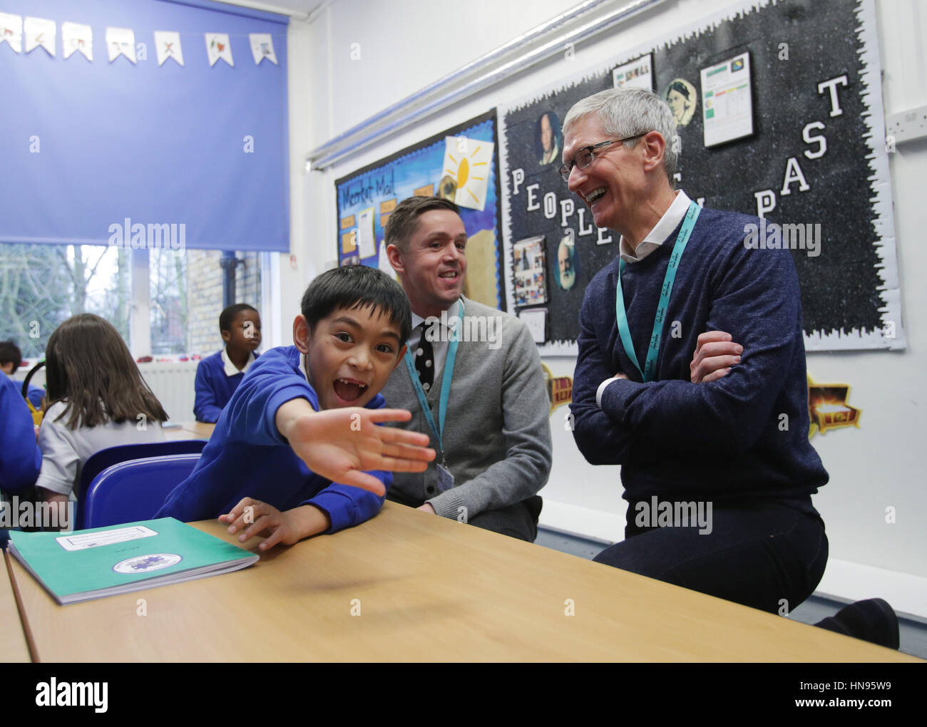 Tim Cook, CEO of Apple, accompanied by headteacher Derek Hewie ...