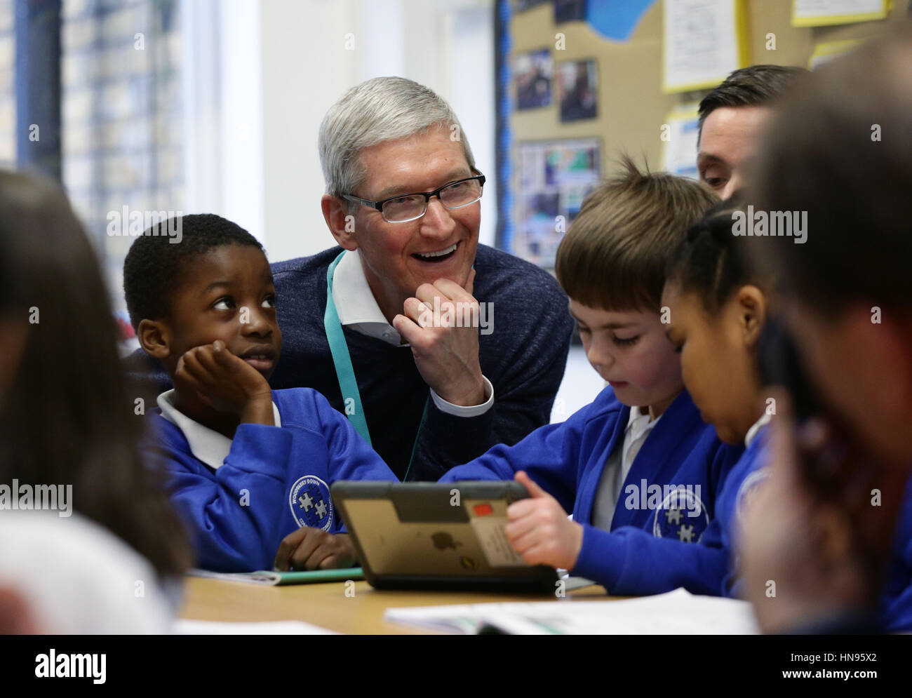 Tim Cook, CEO of Apple, interacts with Year 2 pupils in a classroom ...