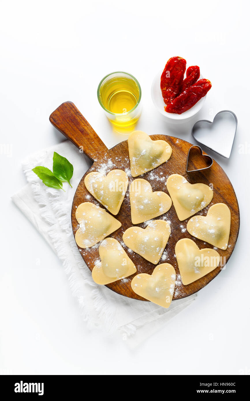 fresh Italian ravioli in shape of heart. food background. on white ...