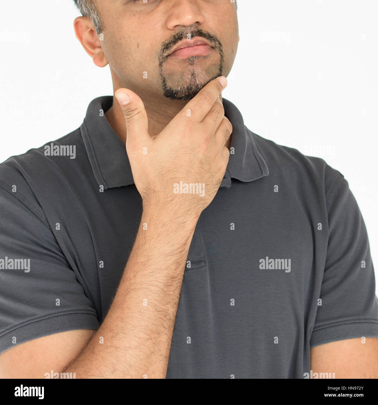 Adult man touching his face thoughtful gesture Stock Photo - Alamy