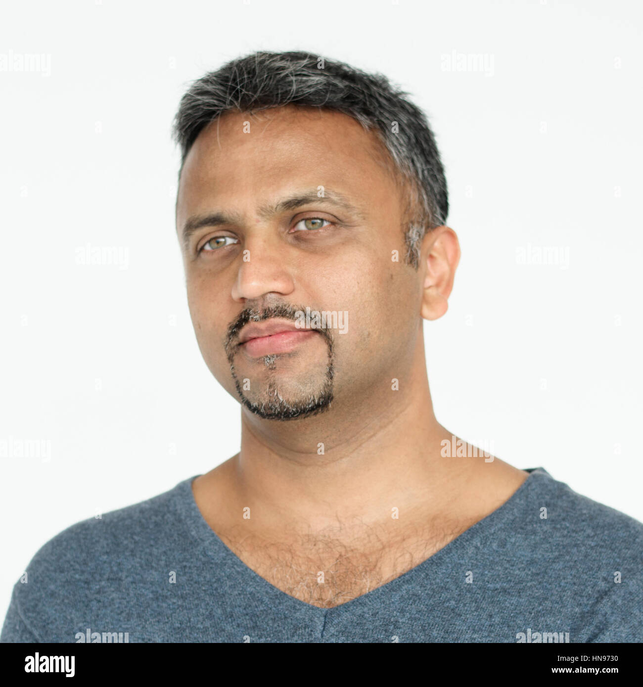 Indian guy thoughtful expression studio portrait Stock Photo - Alamy
