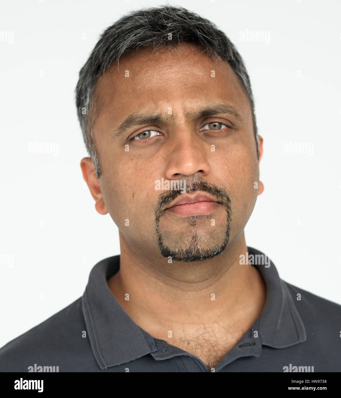 Indian guy thoughtful expression studio portrait Stock Photo - Alamy