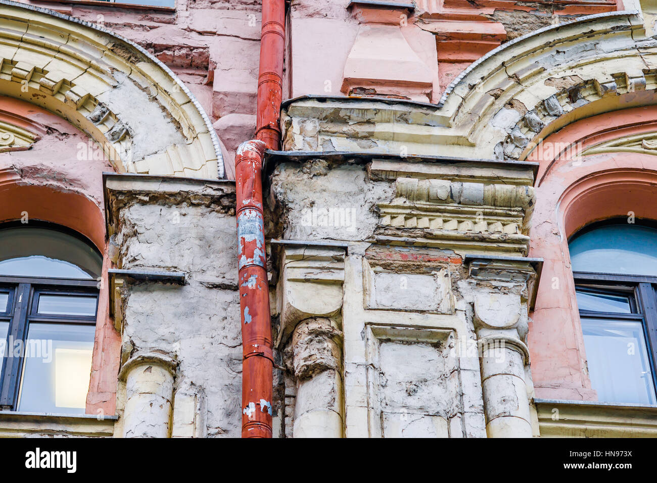 Details of an old building with deteriorated and dilapidated front face ...