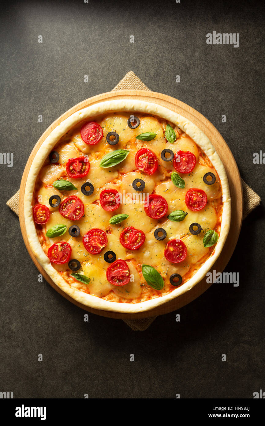 italian pizza at black table background Stock Photo - Alamy