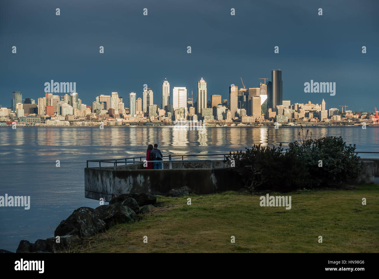 As the sun sets the buildings of the Seattle skyline are relfected in ...