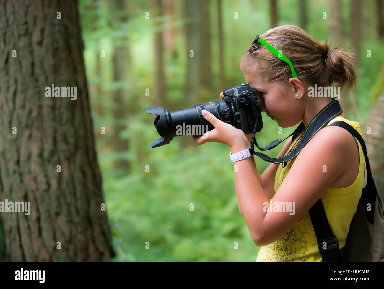 girl with a digital camera taking pictures outside Stock Photo - Alamy