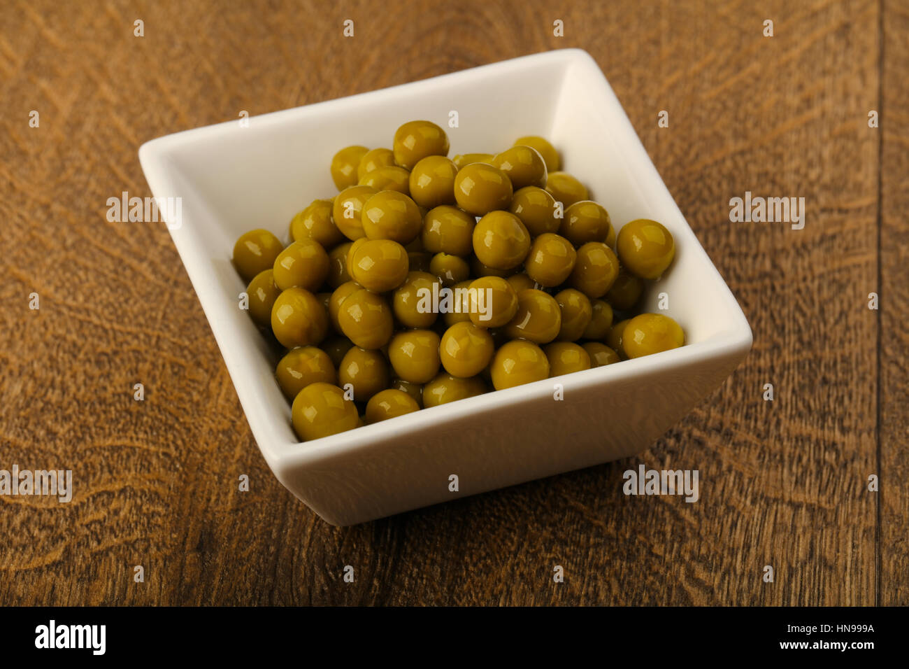 Pickled green pea on the wood background Stock Photo - Alamy