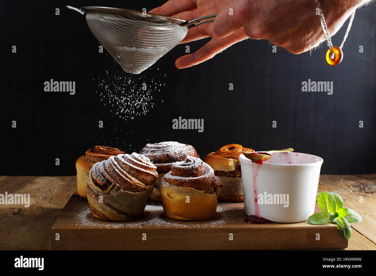 sprinkle with powdered sugar sweet rolls. morning breakfast Stock Photo ...