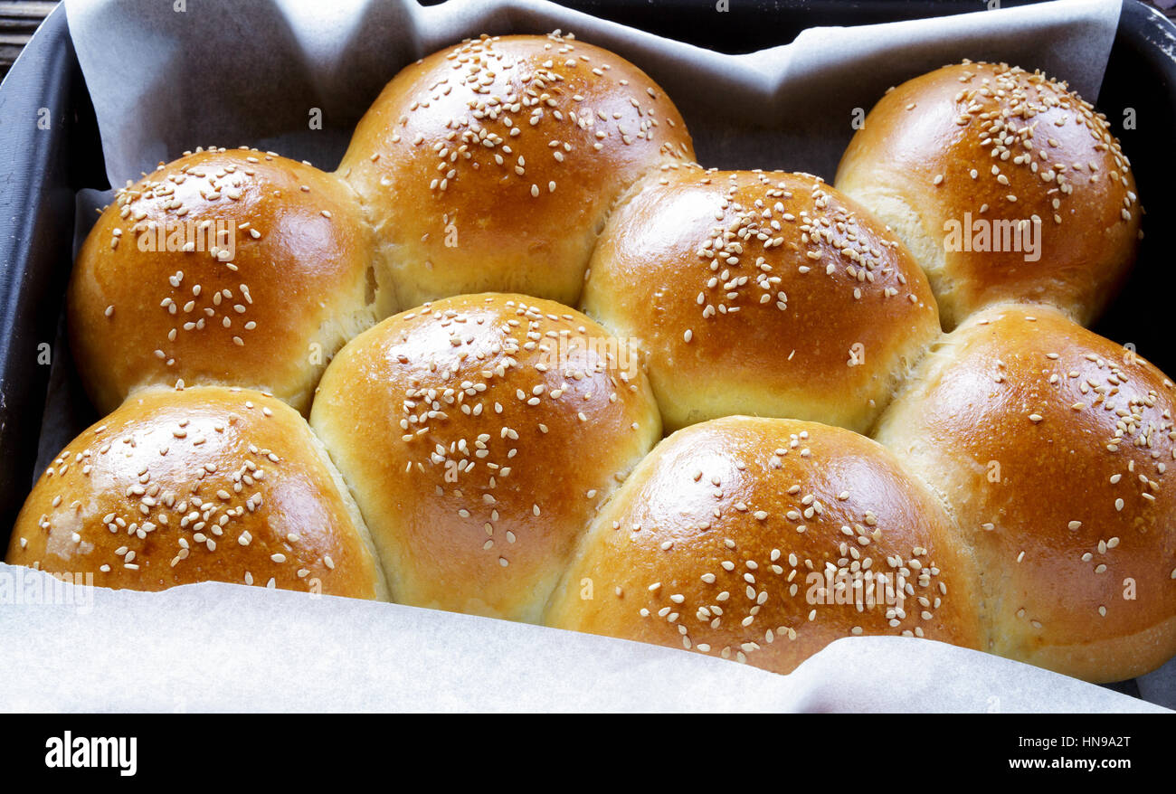 burger bun on a baking sheet on a wooden table Stock Photo - Alamy