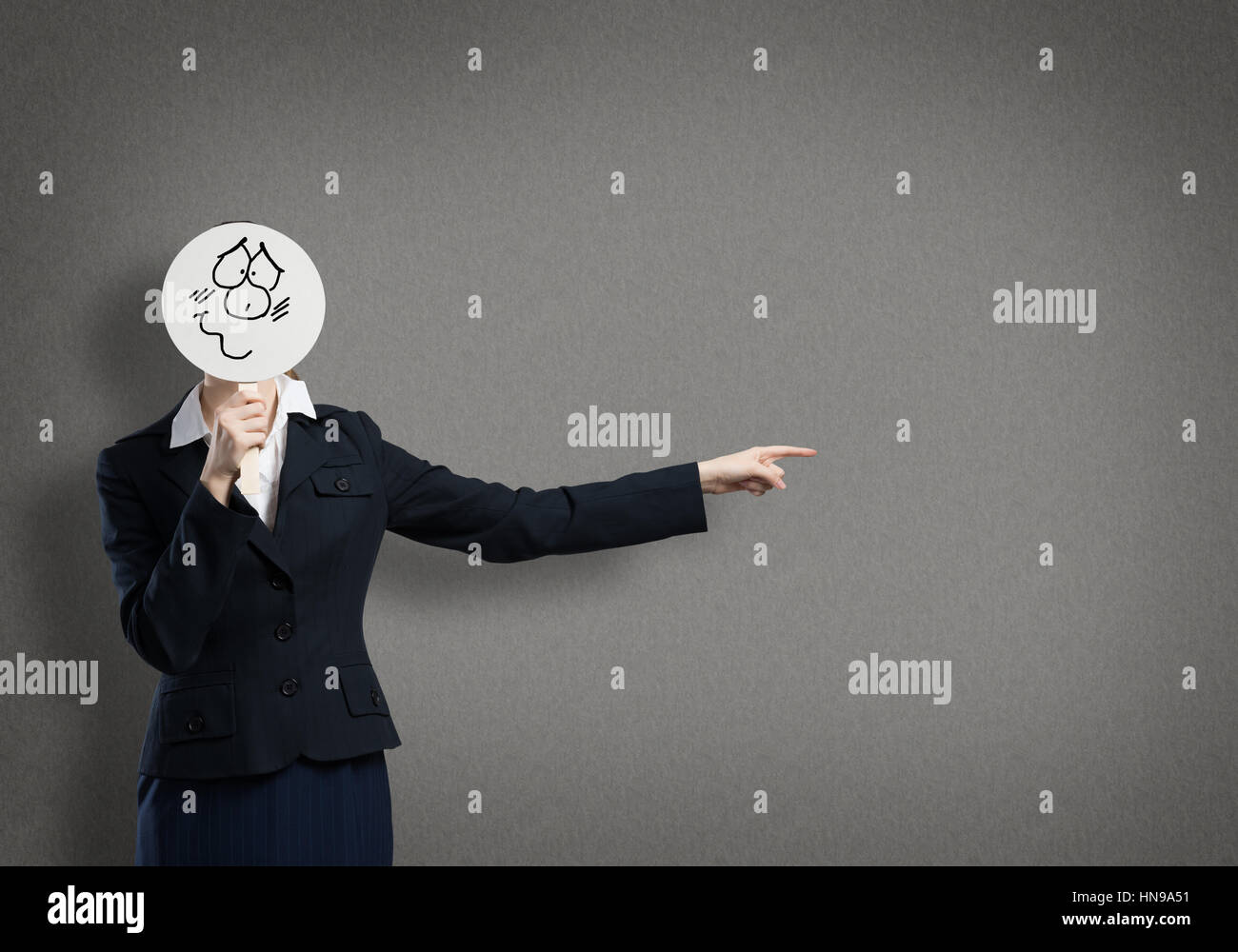Businesswoman hiding her face behind round mask Stock Photo - Alamy