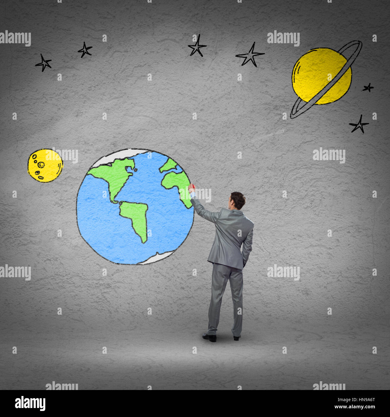 Rear view of businessman presenting drawn Earth planet Stock Photo - Alamy