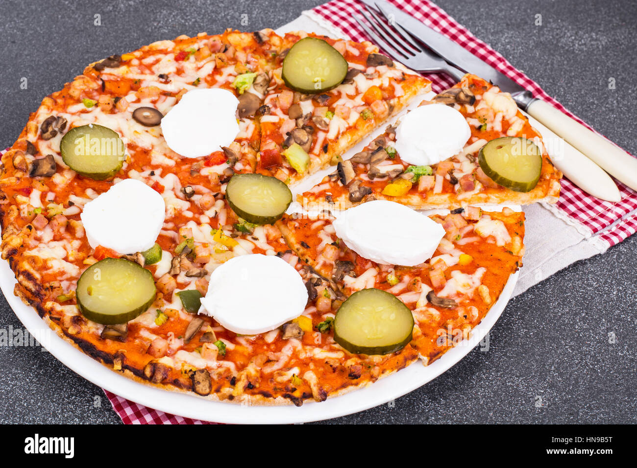 Home pizza with mozzarella and pickled gherkins Stock Photo - Alamy