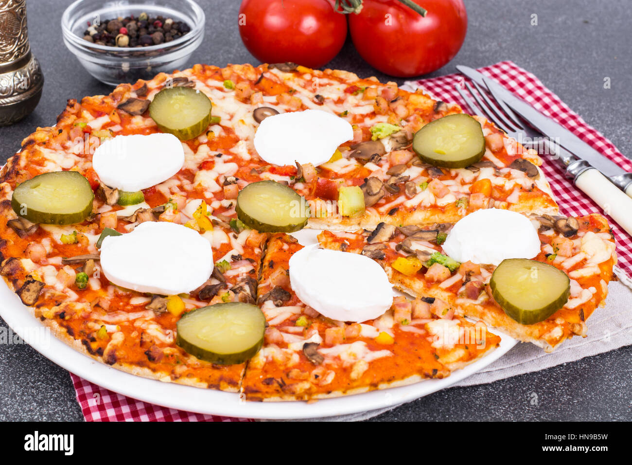 Home pizza with mozzarella and pickled gherkins Stock Photo - Alamy