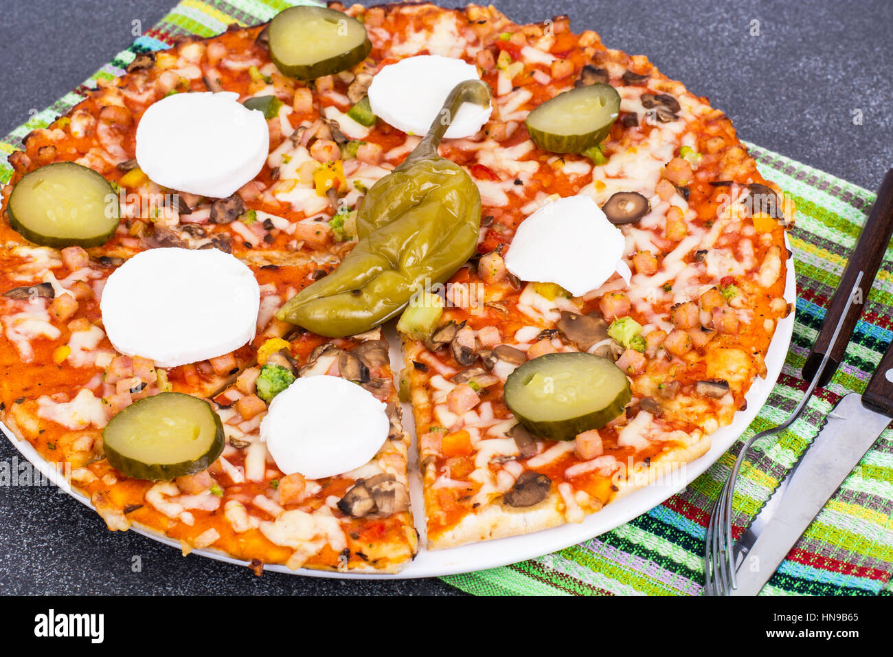 Home pizza with mozzarella and pickled gherkins Stock Photo - Alamy