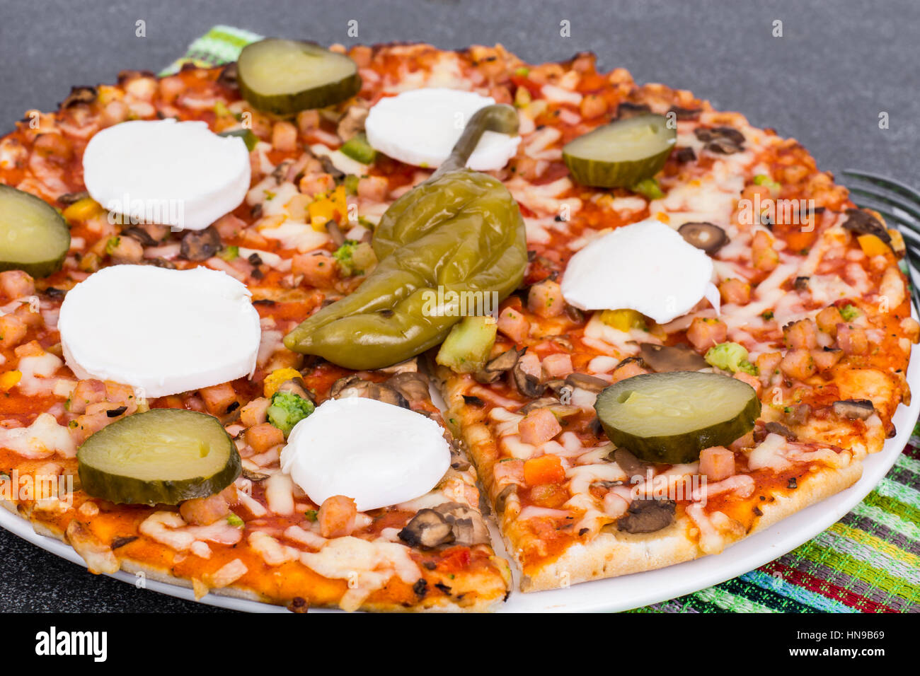 Home pizza with mozzarella and pickled gherkins Stock Photo - Alamy