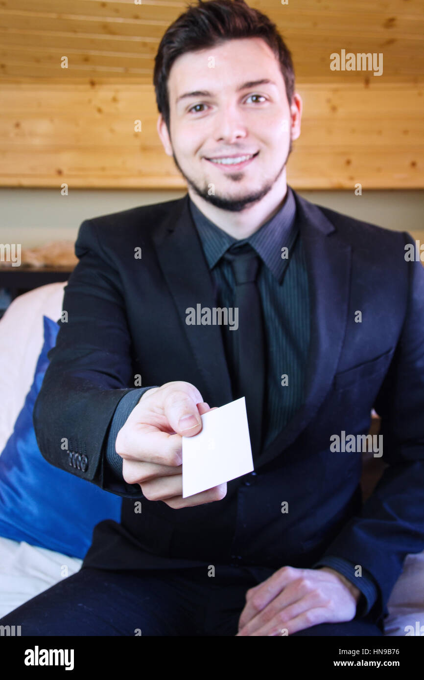 Young businessman showing his calling card Stock Photo - Alamy