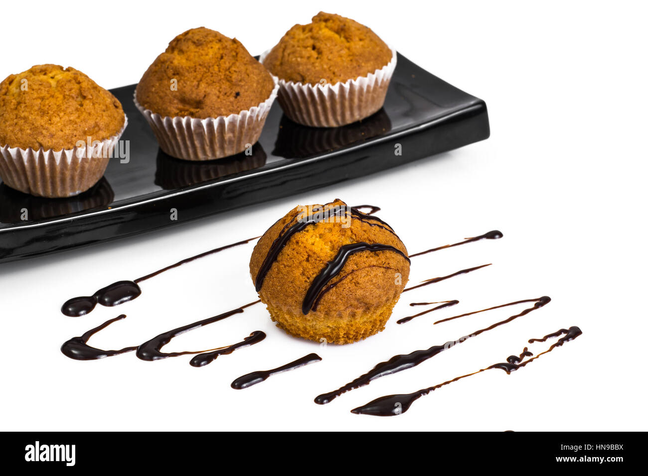 Vanilla mini muffins with chocolate topping Stock Photo - Alamy