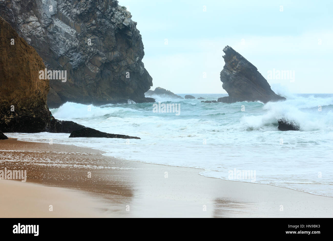 Atlantic ocean waves breaking on granite boulders near beach in stormy ...