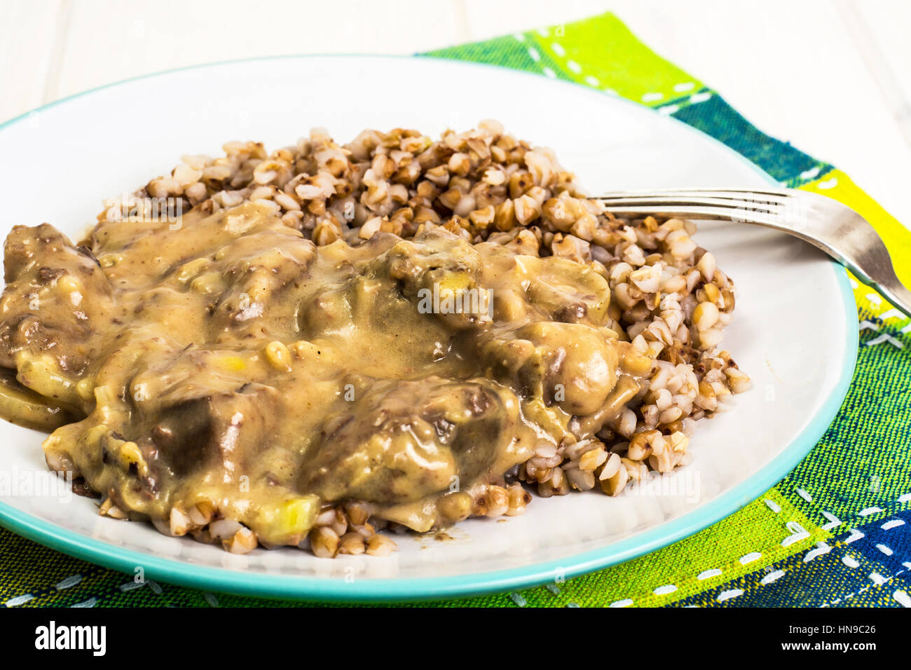 Meat with gravy, buckwheat Stock Photo - Alamy