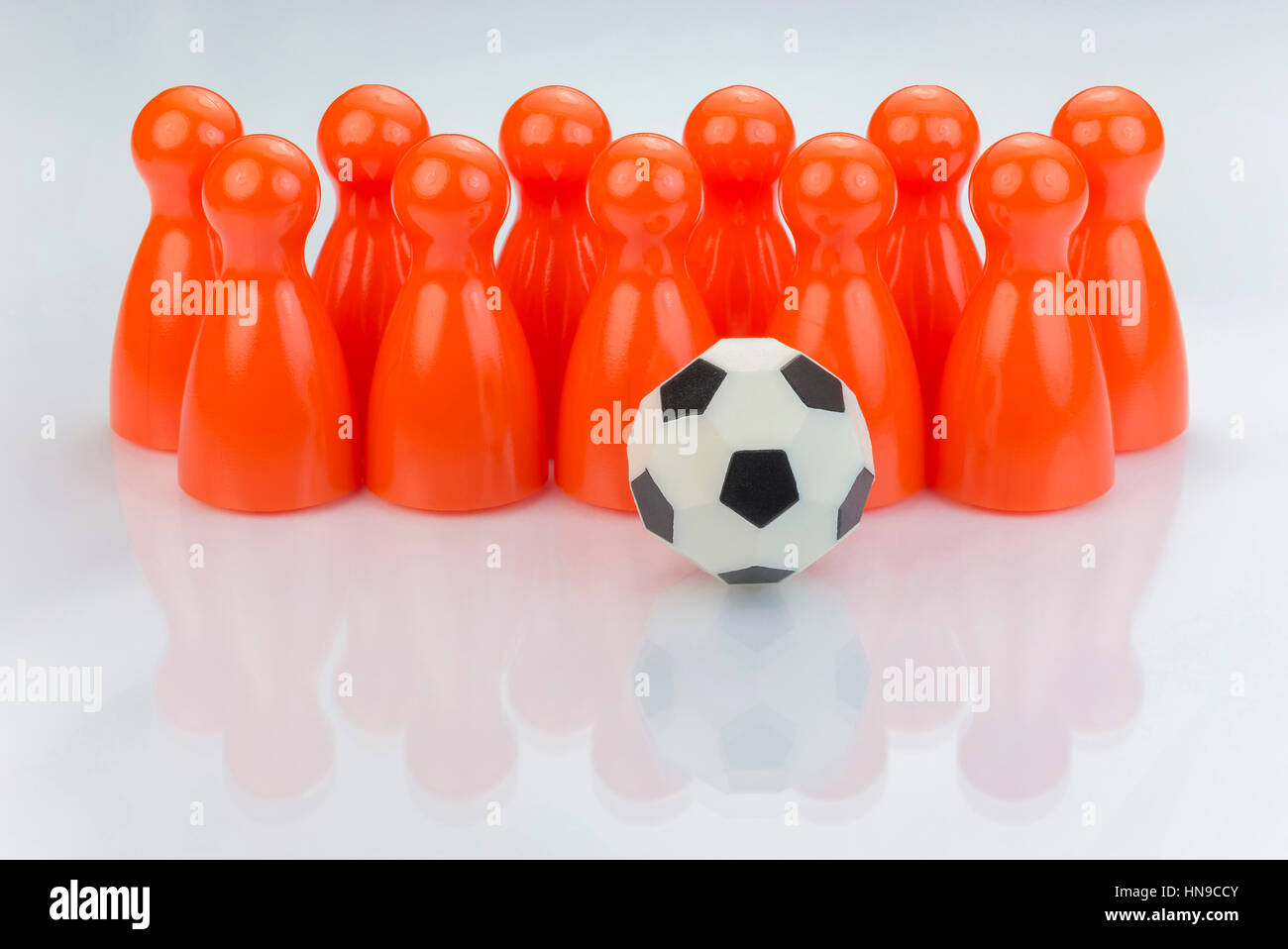 Conceptual orange game pawns as abstract view of a national football ...