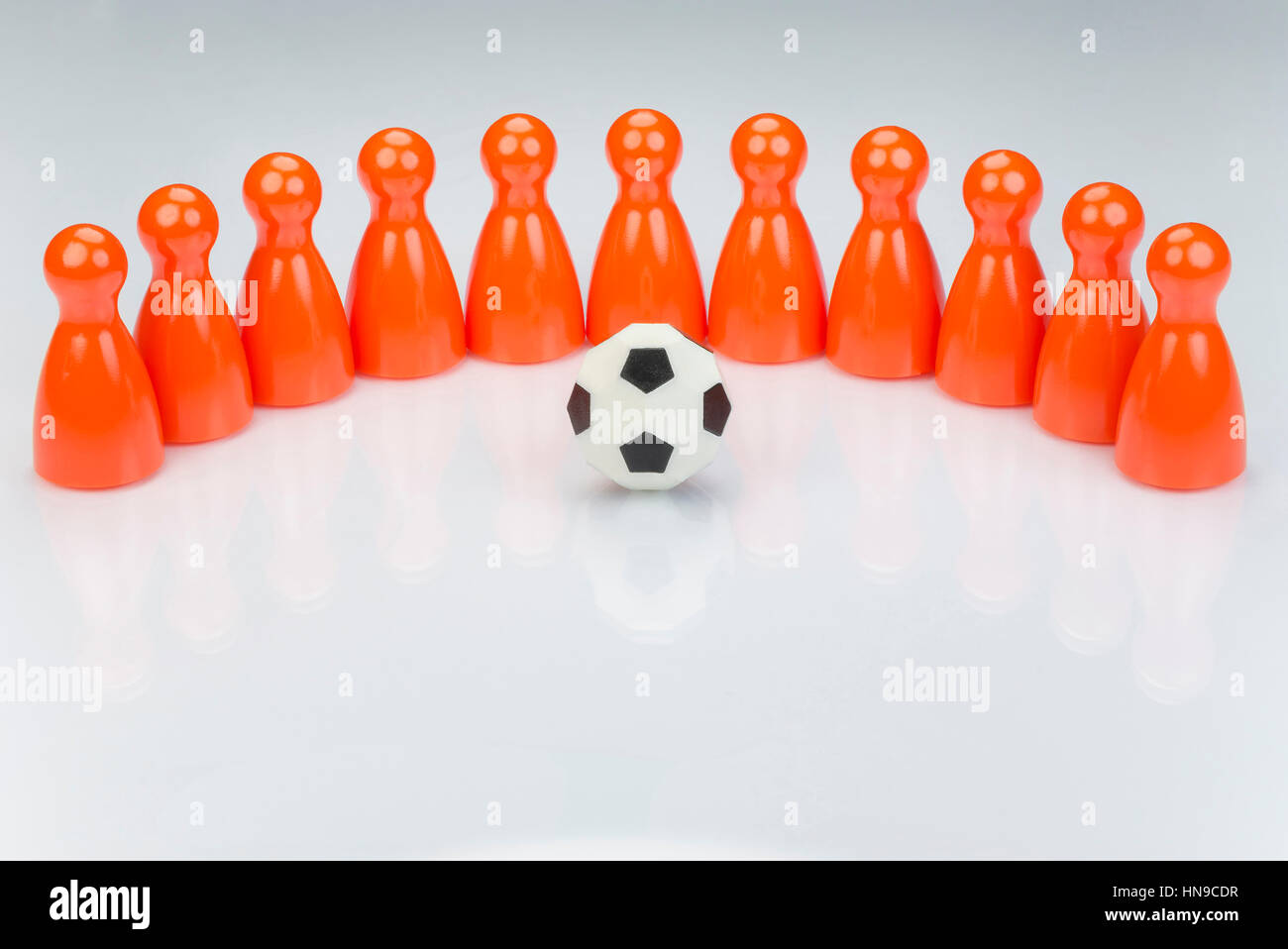 Conceptual orange game pawns as abstract view of a national football ...