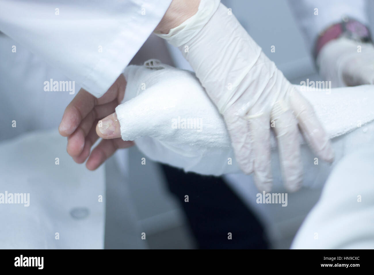 Doctor applying plaster cast bandages hi-res stock photography and ...