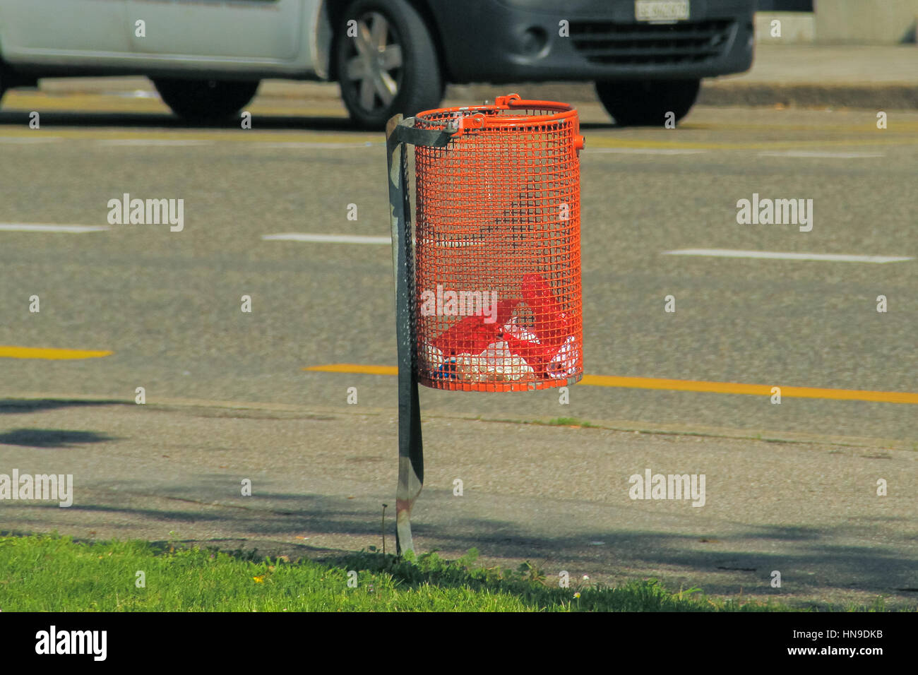 The dustbin beside the road with cars Stock Photo - Alamy