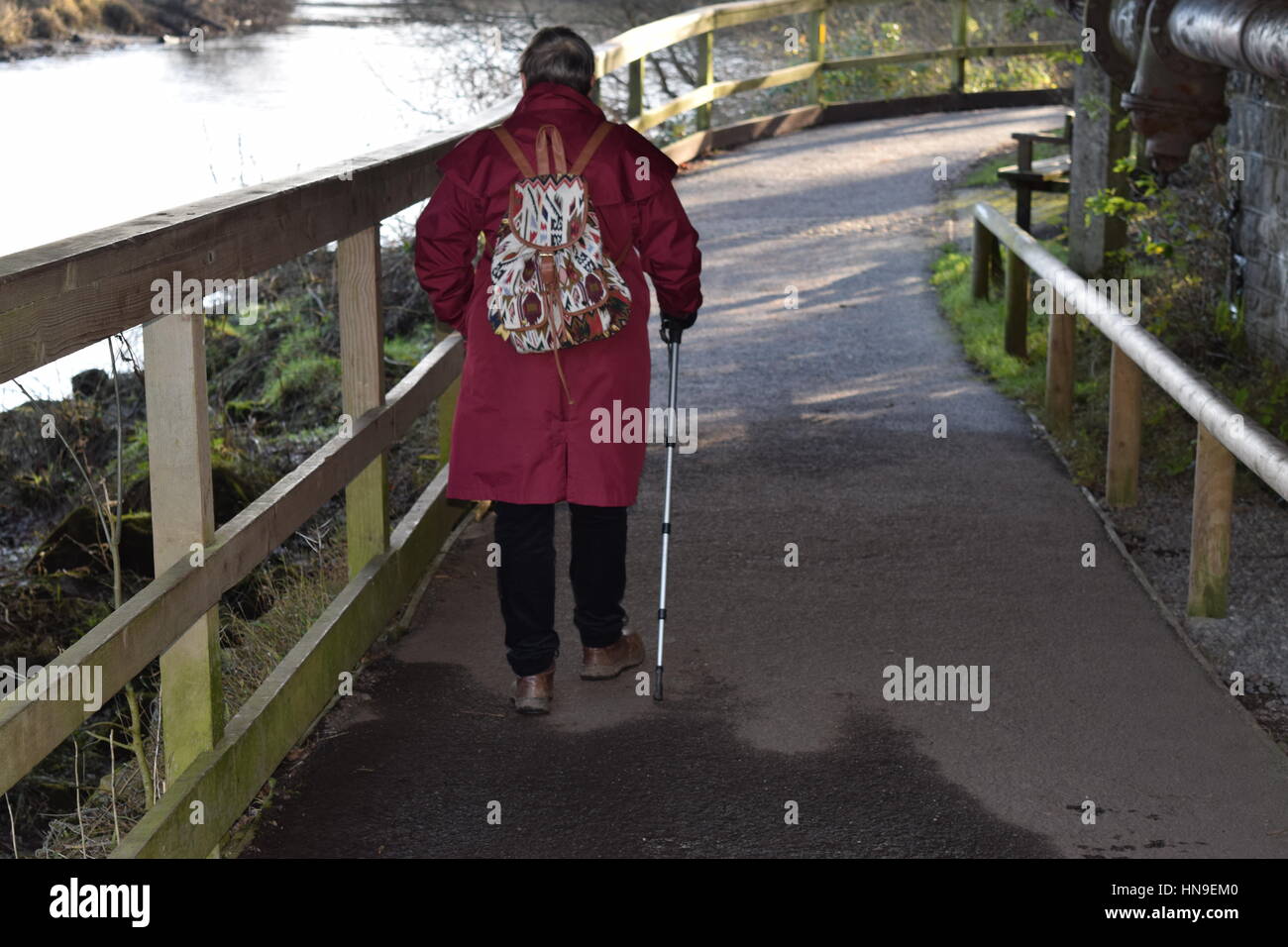 Person walking on a path with a walking stick Stock Photo - Alamy