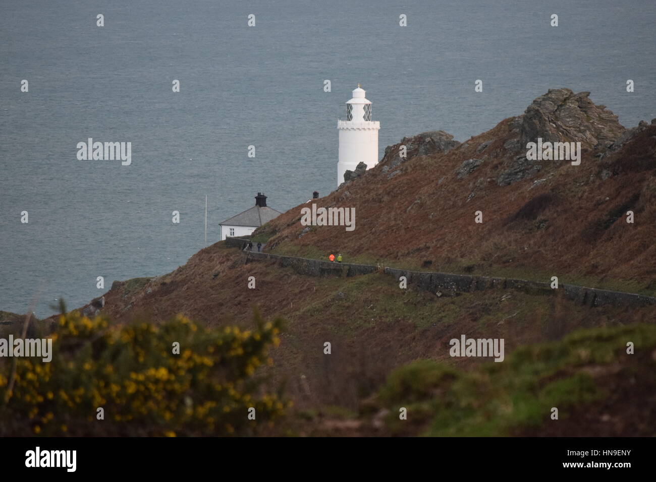 Tall white lighthouse in the distance Stock Photo - Alamy