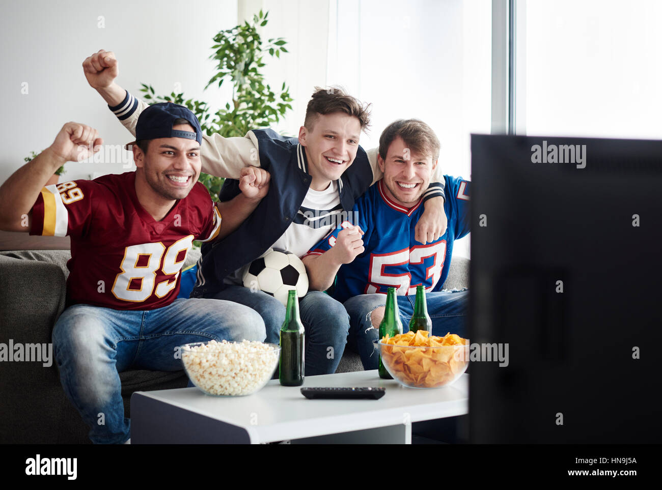 Top view of cheering guys at home Stock Photo - Alamy