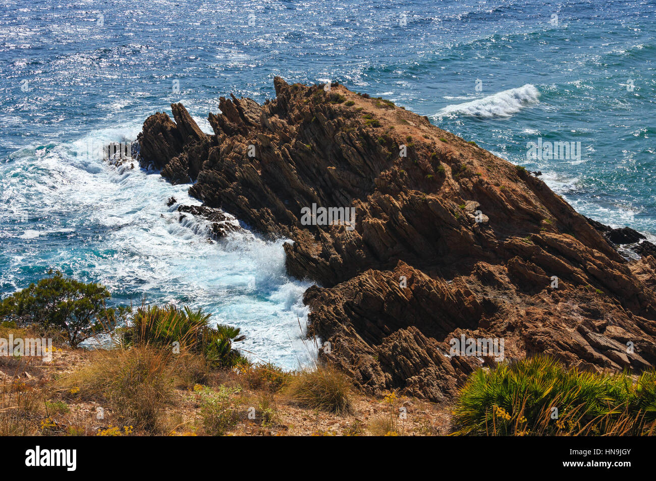 Mediterranean sea summer rocky coast view with sun reflection on water ...