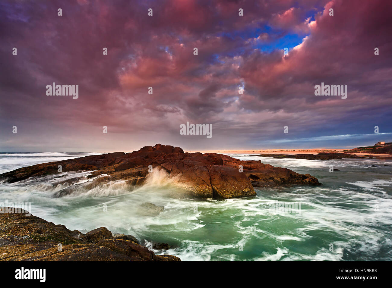 Strong waves and wind overflowing over sandstone rocks at Stockton ...