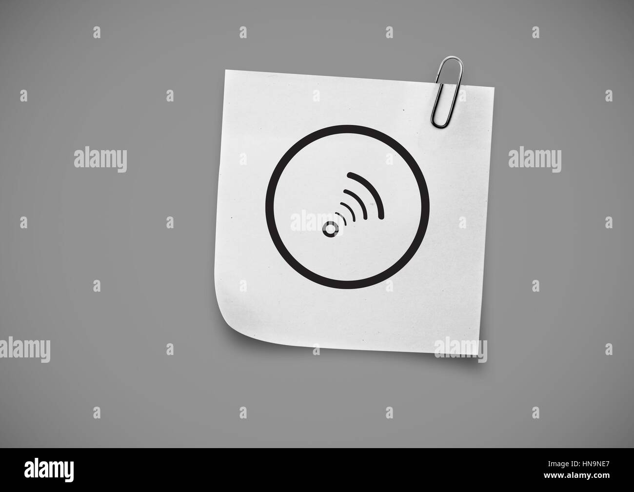 Digital composite of Sticky Note with Wifi Icon against a neutral grey ...