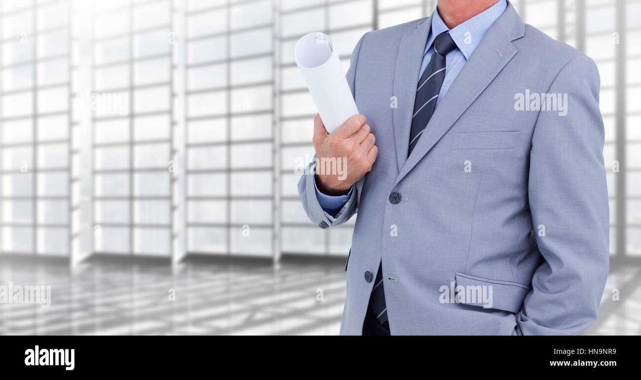 Digital composite of Architect Torso holding plans in a corridor ...