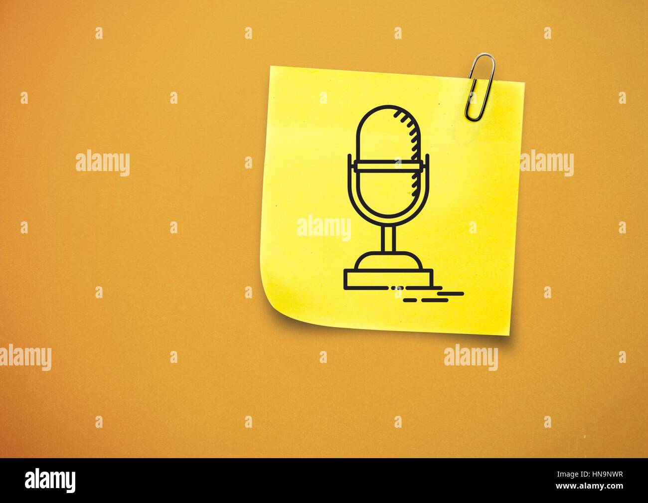 Digital composite of Sticky Note with Microphone Icon against orange ...